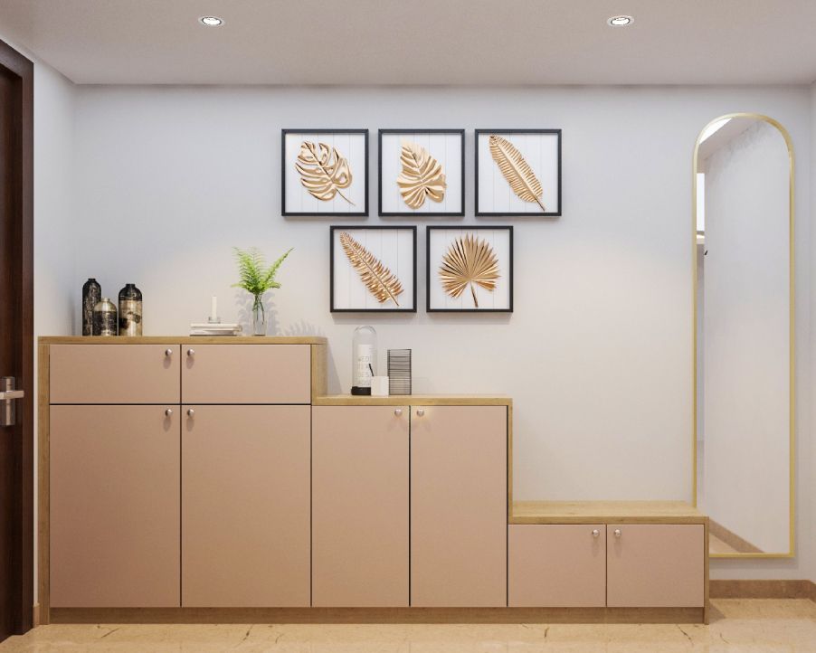 Spacious Foyer Design With Framed Art On The White Back Wall | Livspace