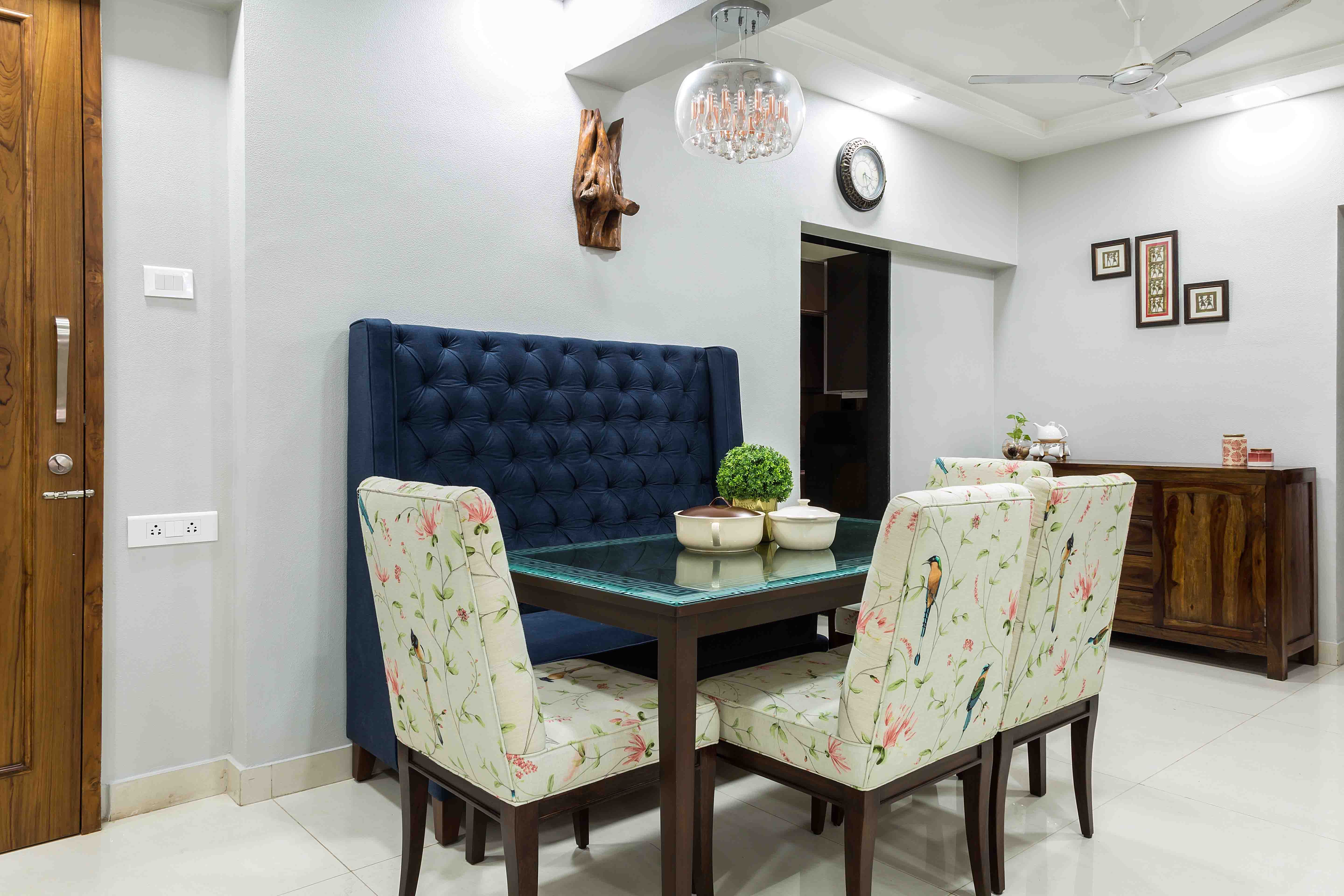 Dining Room Design With Nature-Themed Chairs And Blue Velvet Seater ...
