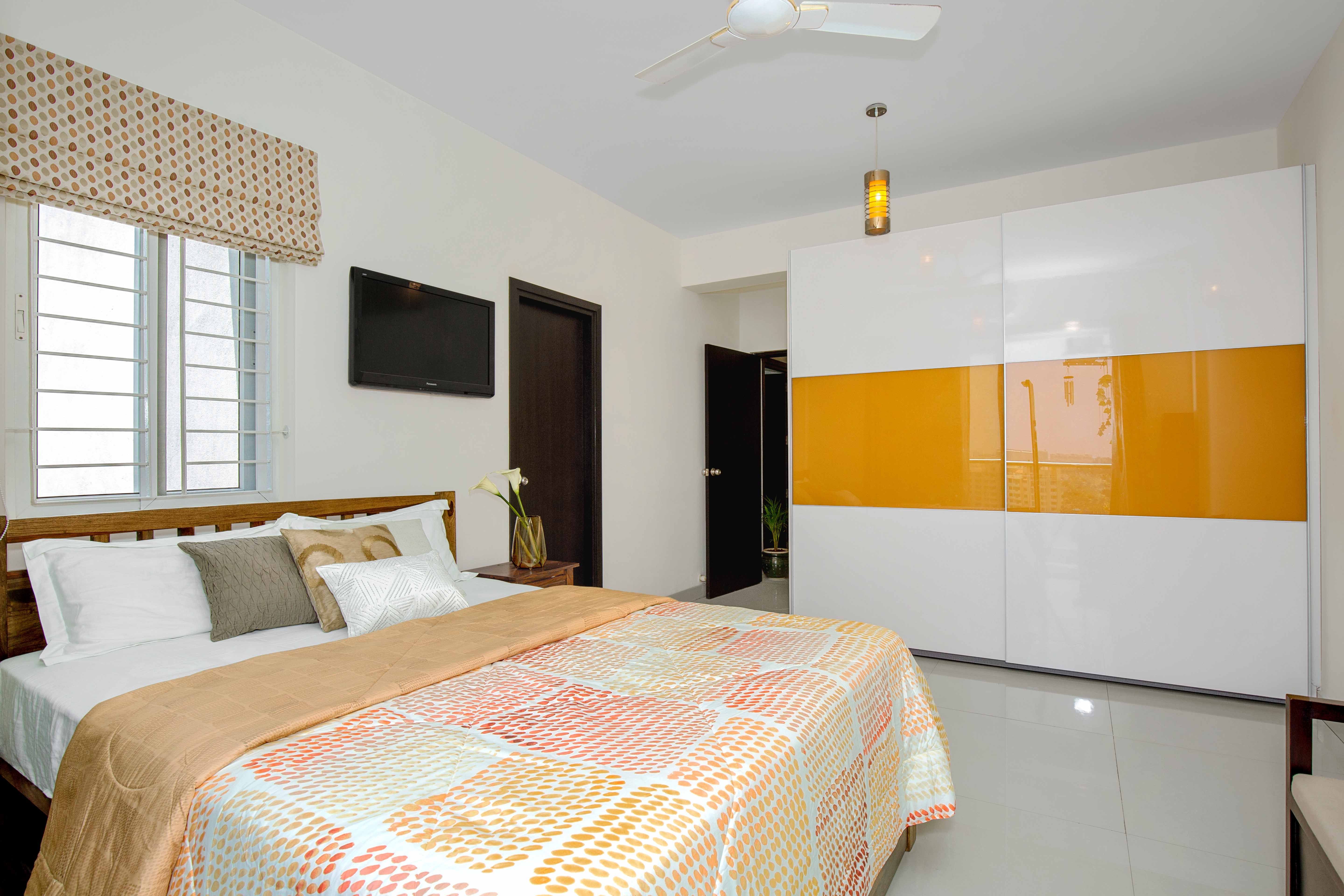 Guest Room Design With White And Yellow Glossy Sliding Wardrobe | Livspace