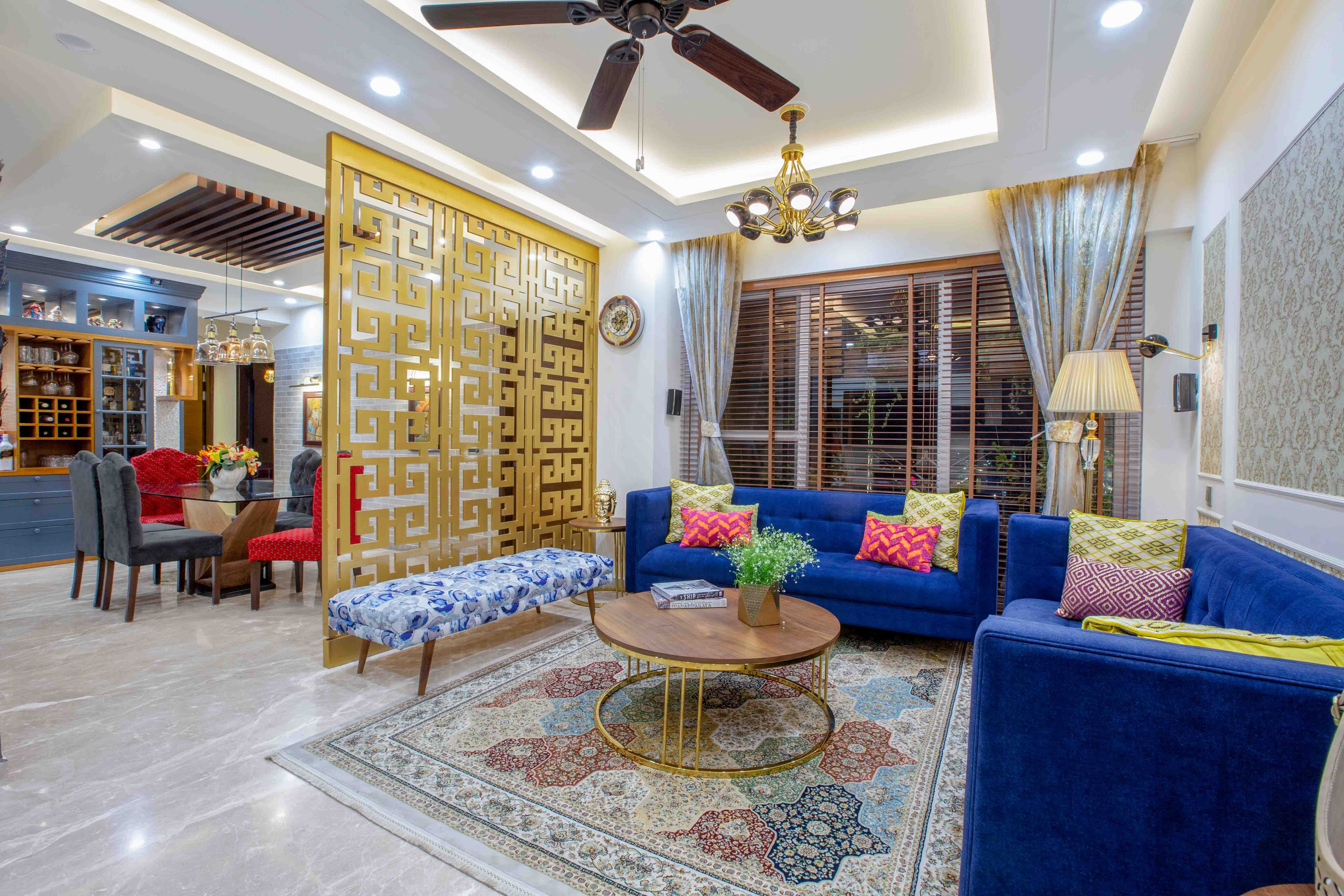 3-BHK Flat In Noida With Bright Blue L Shaped Living Room And Gold ...