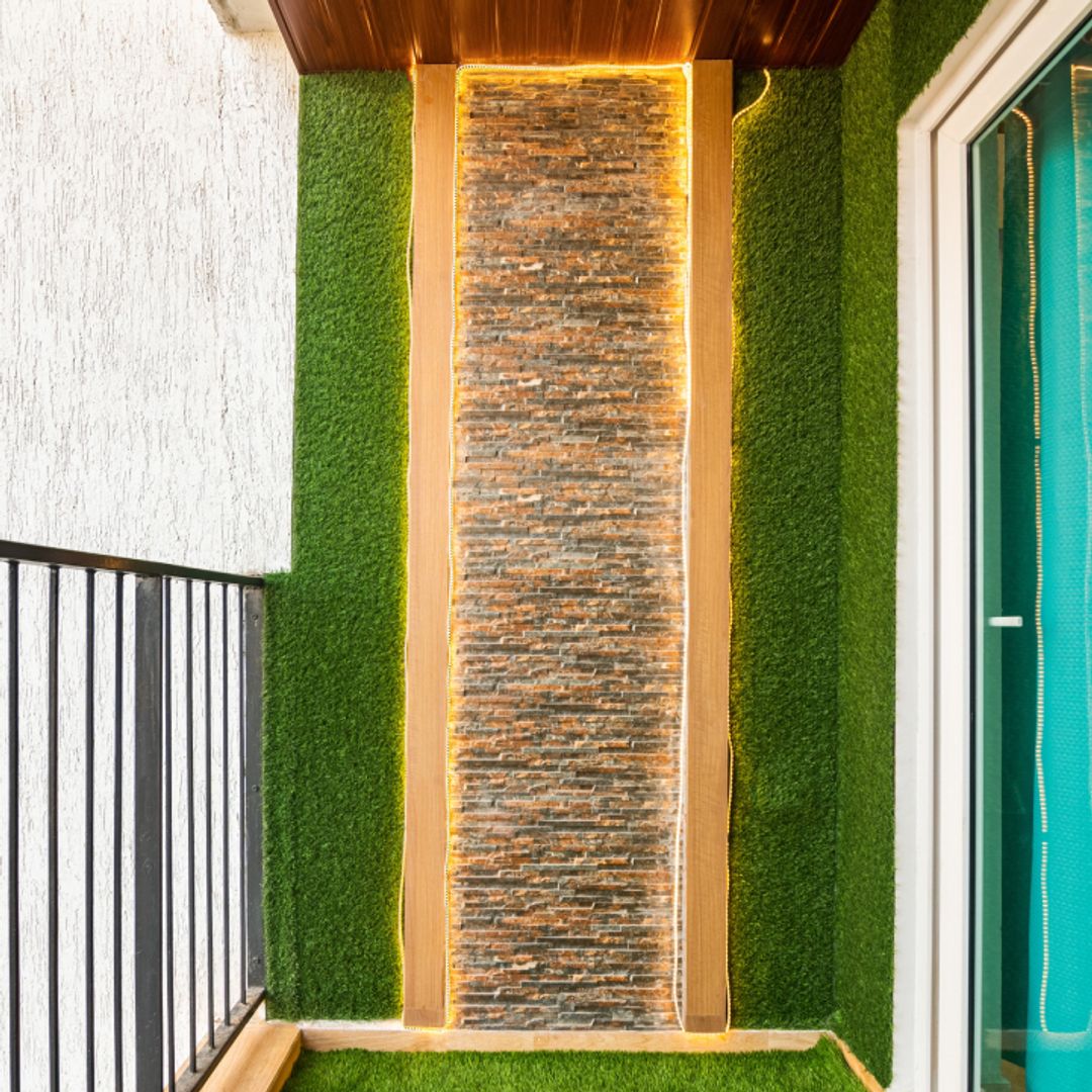 Compact Balcony Design With Grass Wall Panelling | Livspace