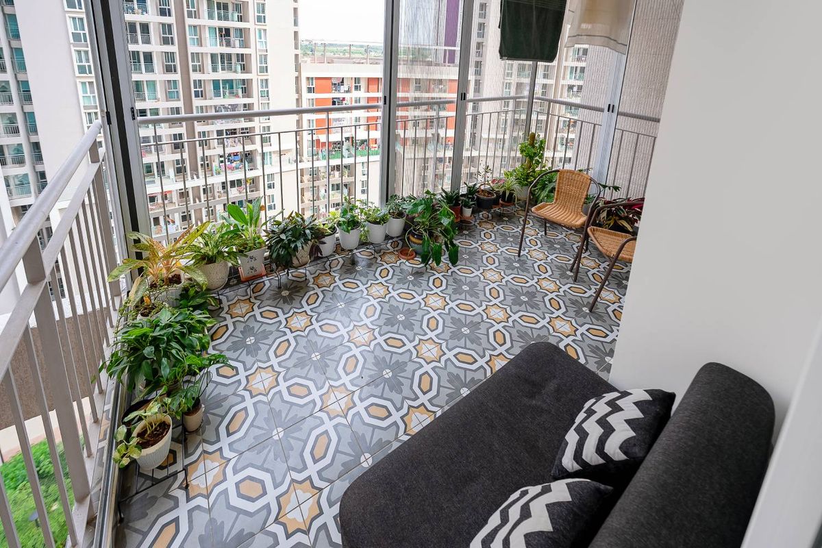 Modern Balcony Design with Green Plants, Wicker Chairs and Tiles | Livspace