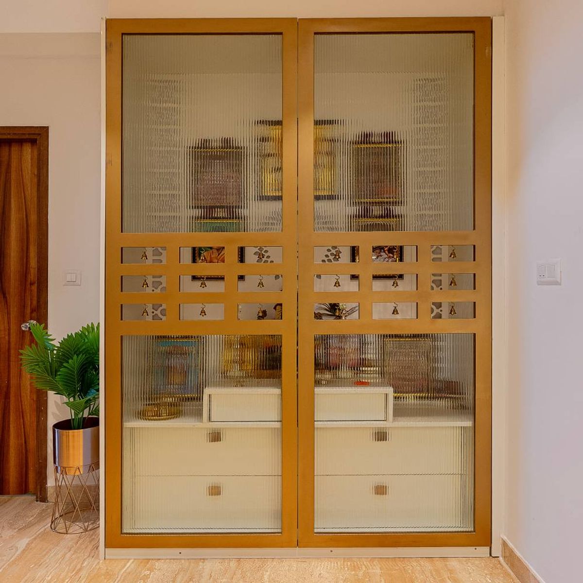 Modern Pooja Room Design with Golden Sliding Doors Fluted Glass and ...