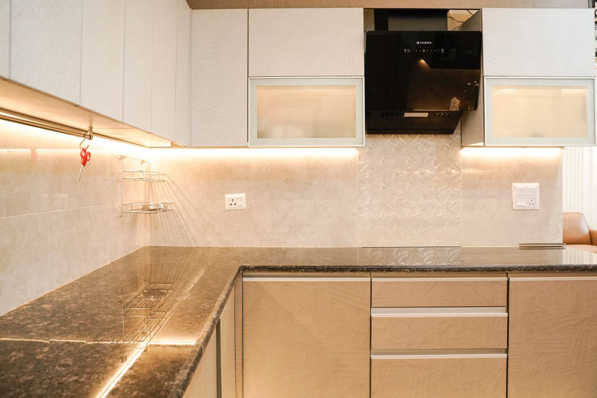 L-Shaped Contemporary Kitchen Design with Beige Cabinets and Granite Countertop | Livspace