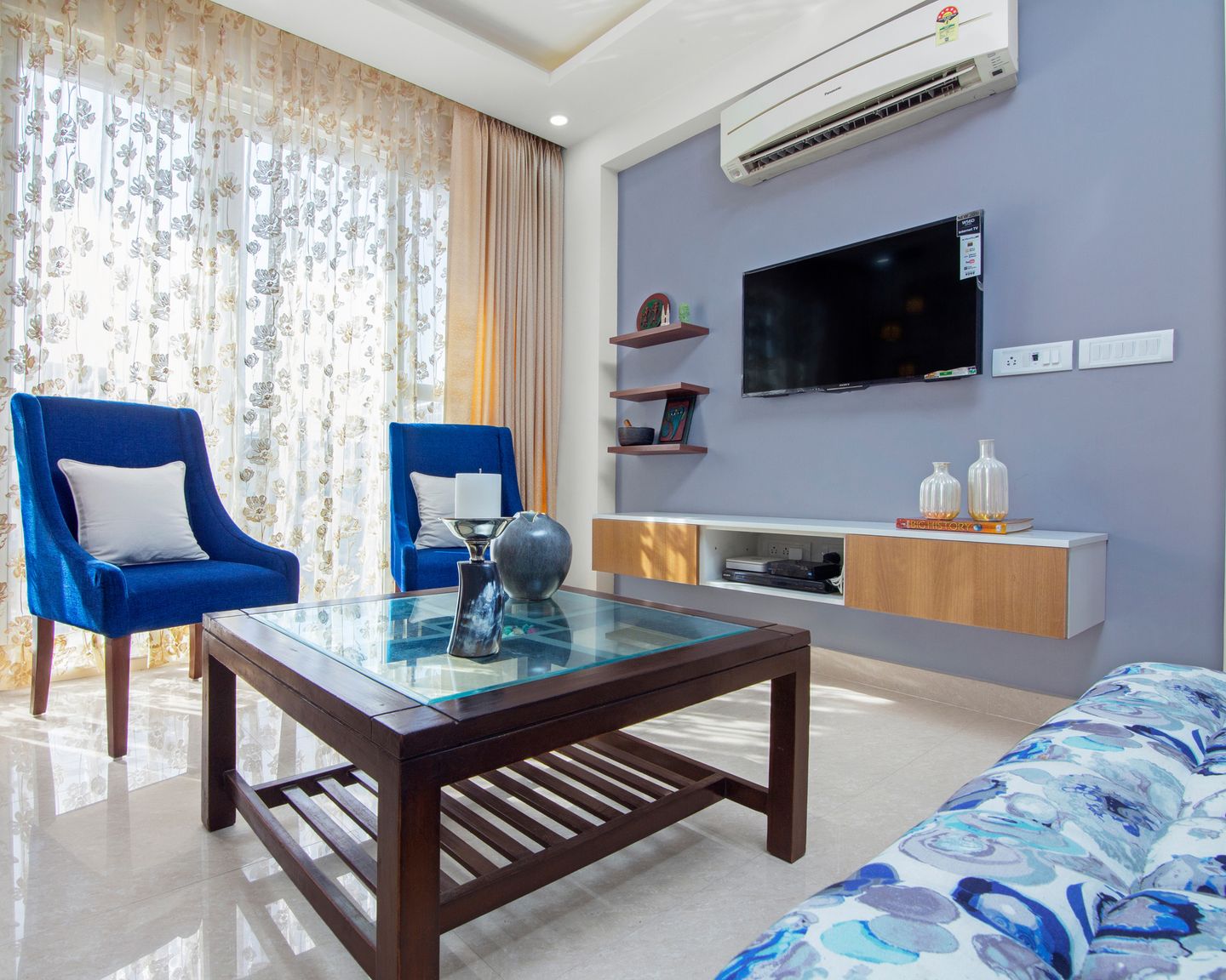White And Bronze TV Unit Design With Glossy Accent Wall | Livspace