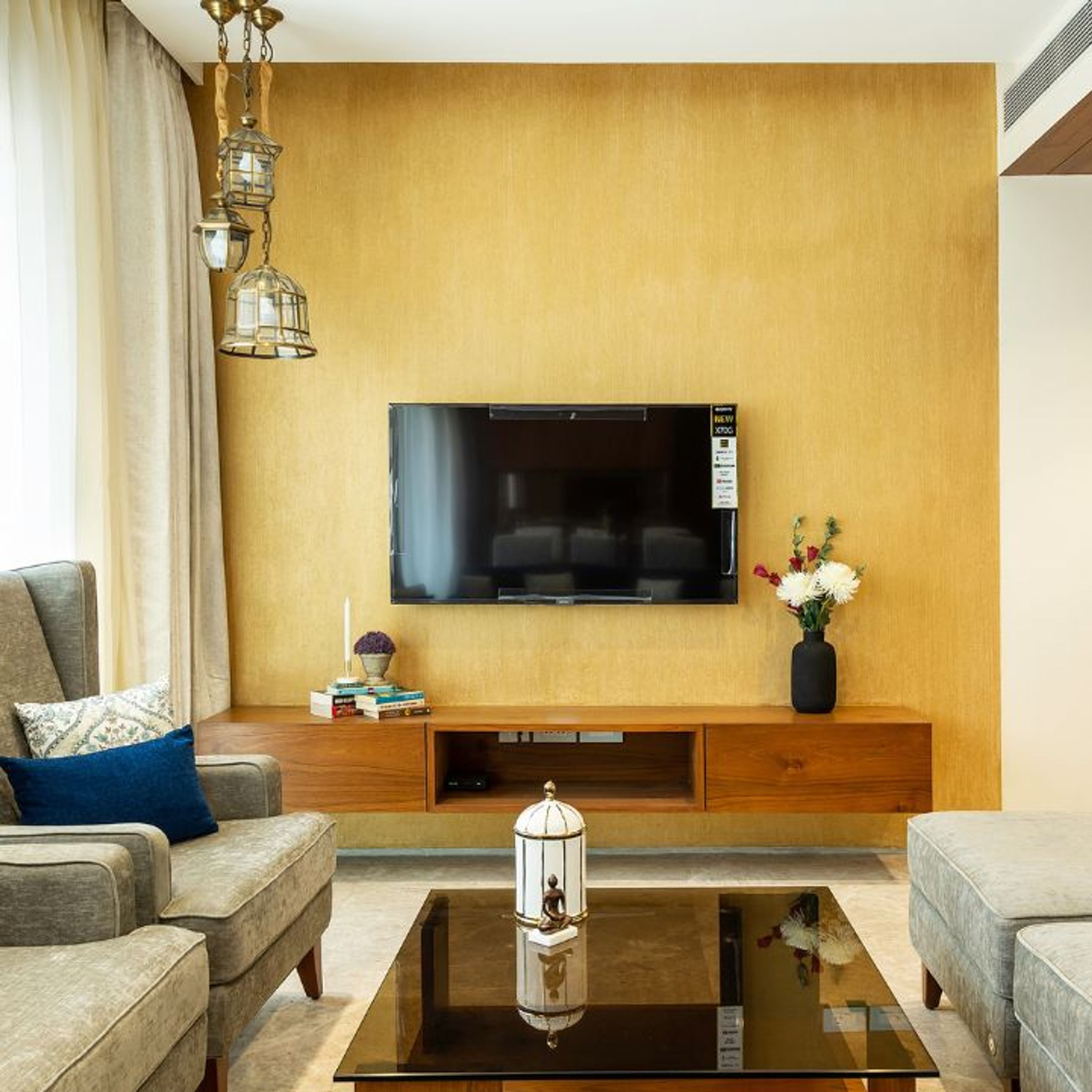 Warm-Toned Living Room Wall Paint With Pendant Lights | Livspace