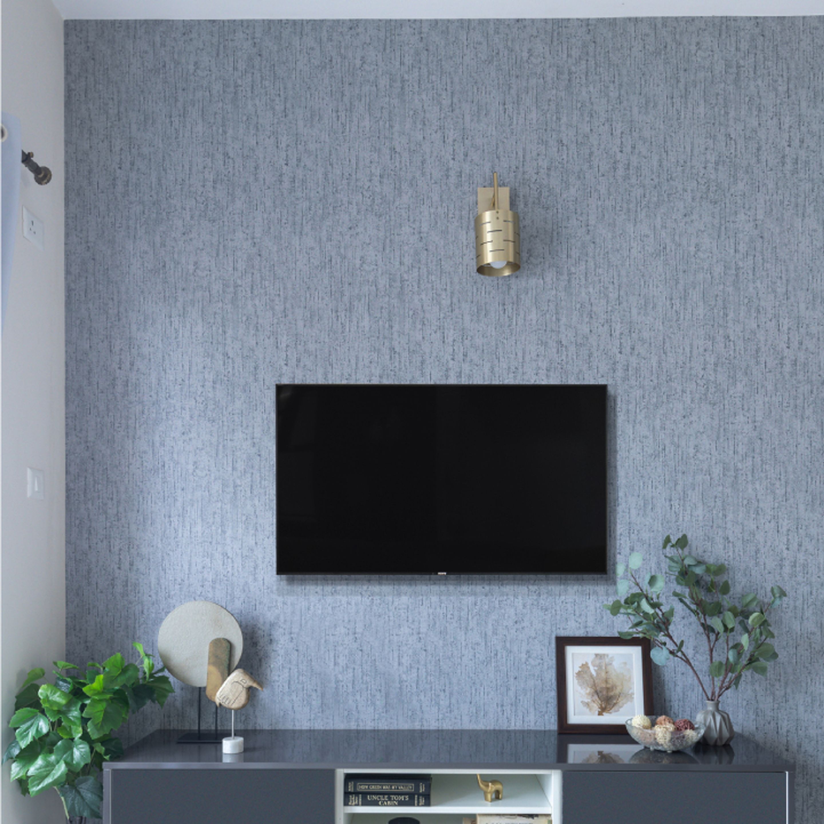 Blue Textured Living Room Wallpaper With Golden Sconce | Livspace