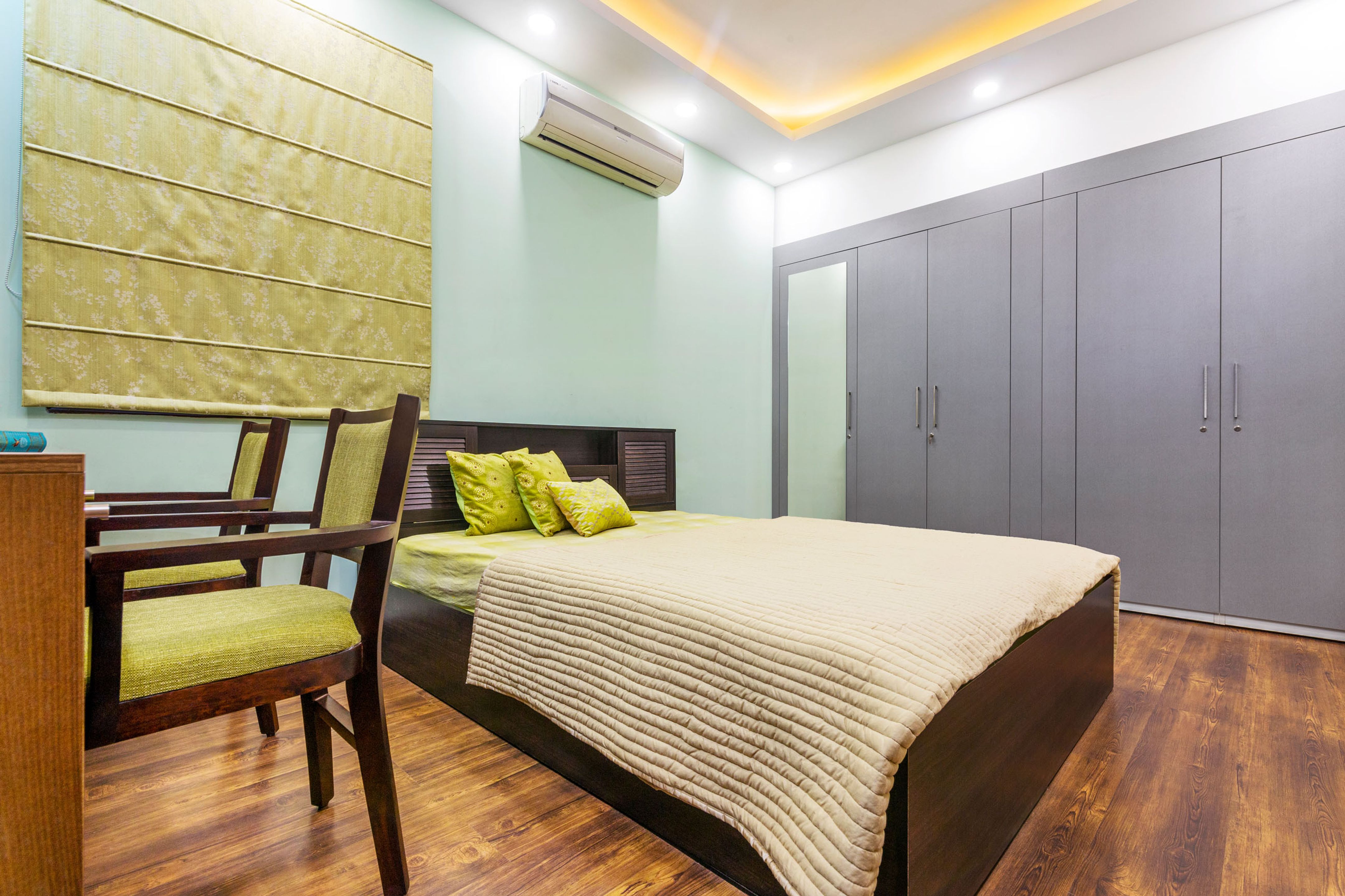 Spacious Guest Room Design With King-Sized Bed And Wooden Wardrobe ...