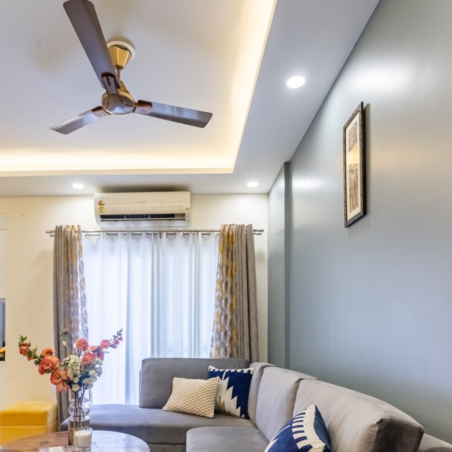 Spacious False Ceiling Design With Pretty Grey Couch | Livspace