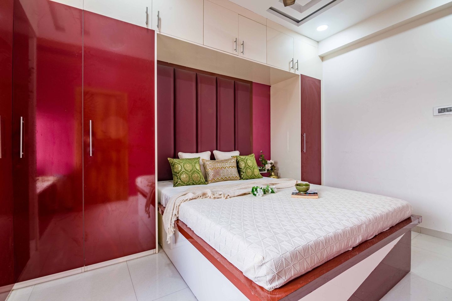 Space-Saving Bedroom Design With Murphy Bed And Integrated Glossy Red-White Wardrobe | Livspace