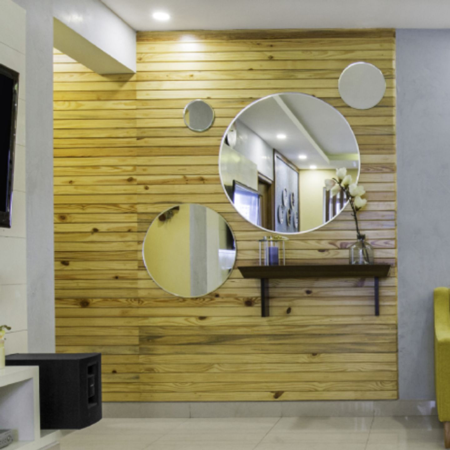 Spacious Foyer Design With Wooden Accent Wall And Mirrors | Livspace