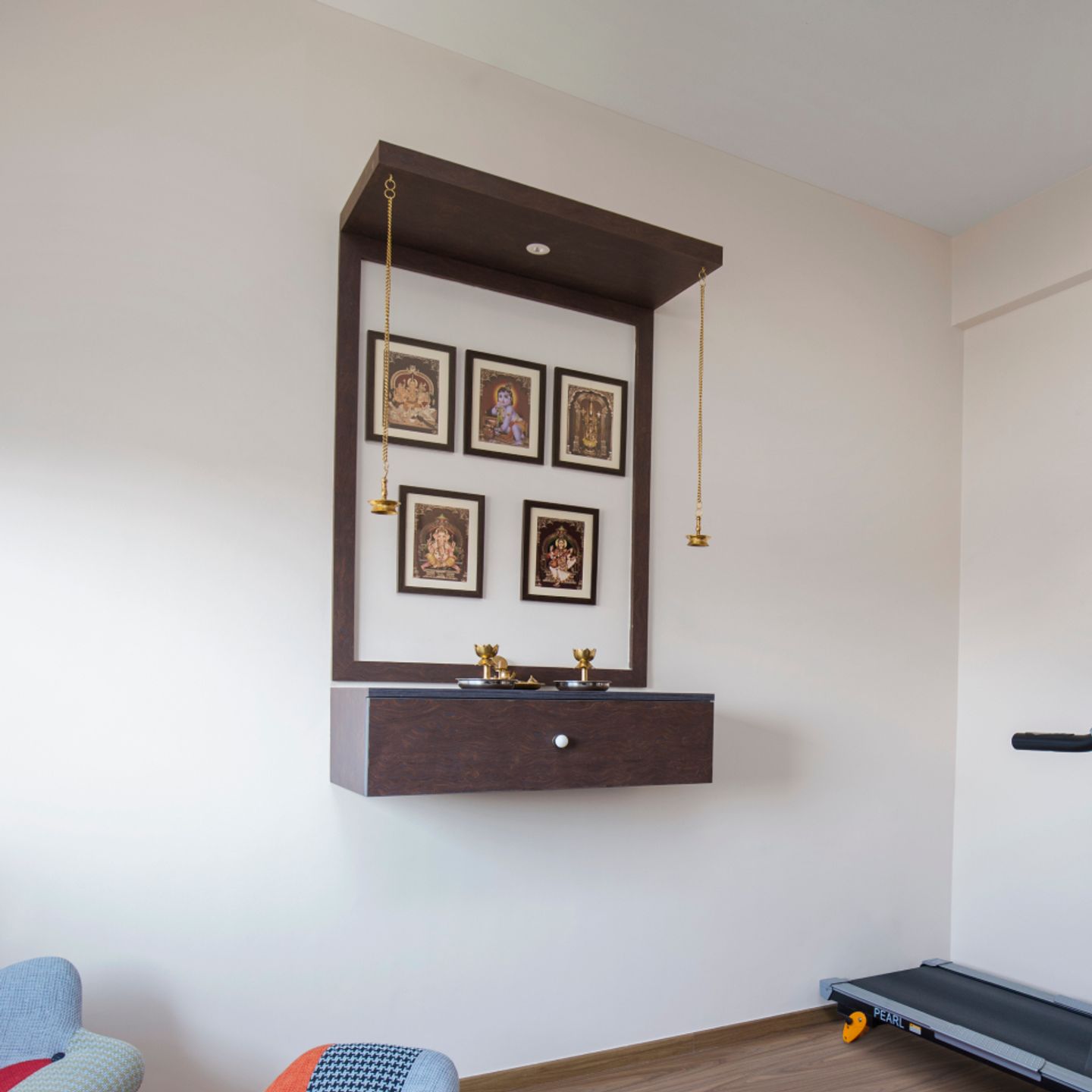 Wall-Mounted Compact Pooja Room Design With A Wooden Countertop | Livspace