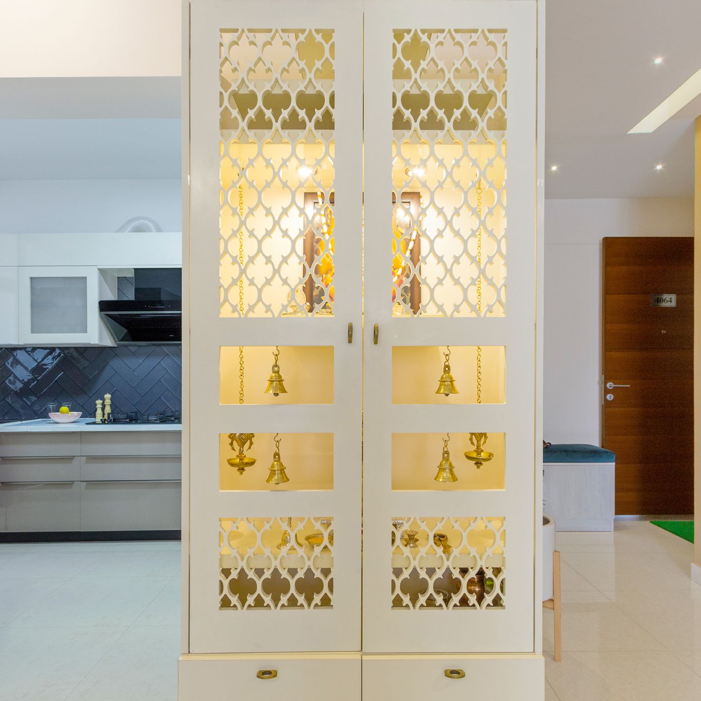 Frosty White Mandir Design With Perforated Door And Bells | Livspace Frosty White Mandir Design With Perforated Door And Bells | Livspace