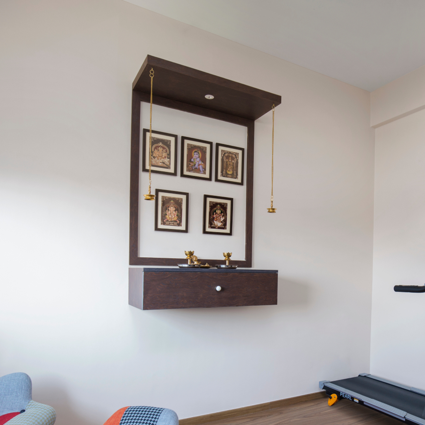 Wall-Mounted Compact Pooja Room Design With A Wooden Countertop | Livspace