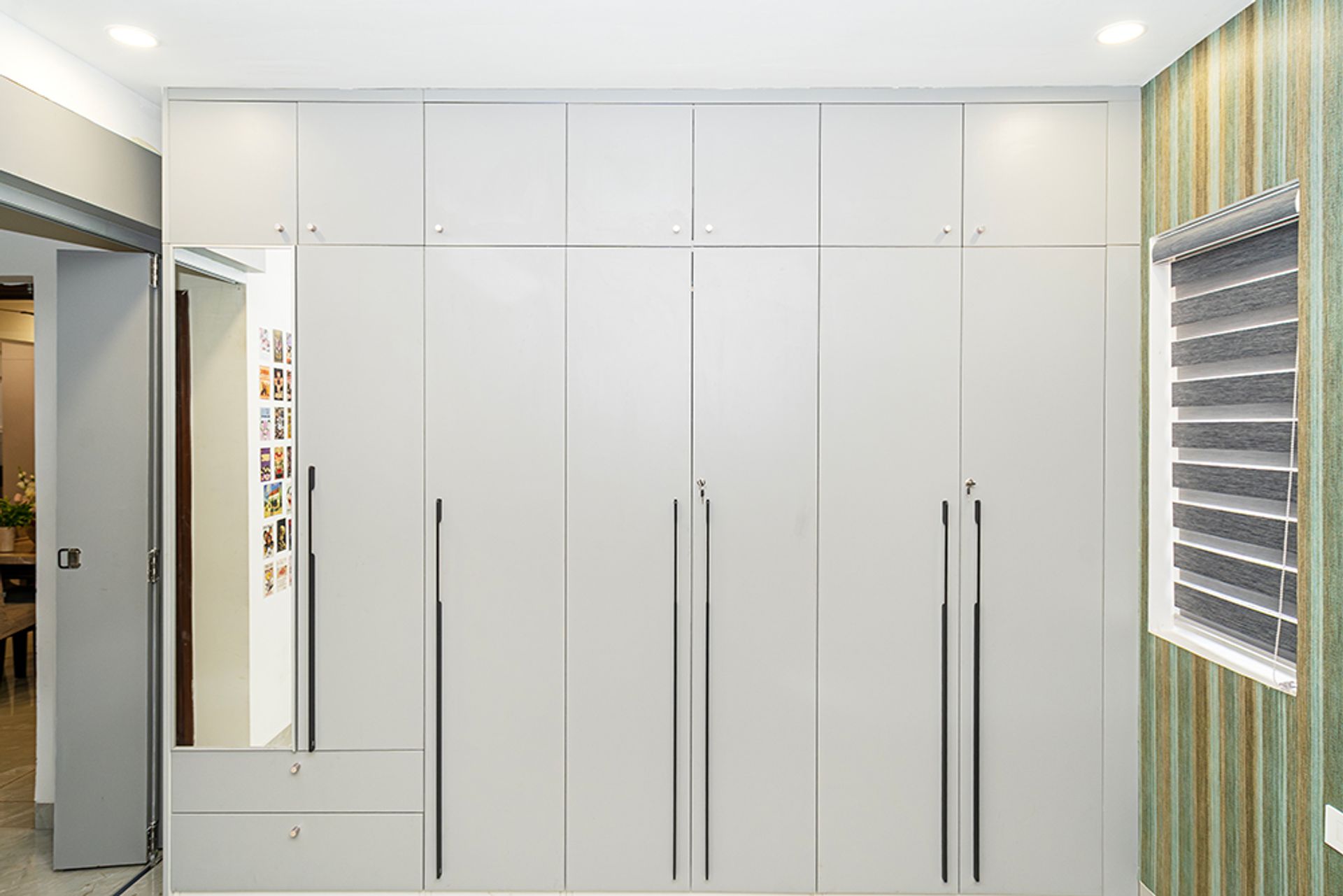 7-Door White Modern Swing Wardrobe Design with Lofts | Livspace