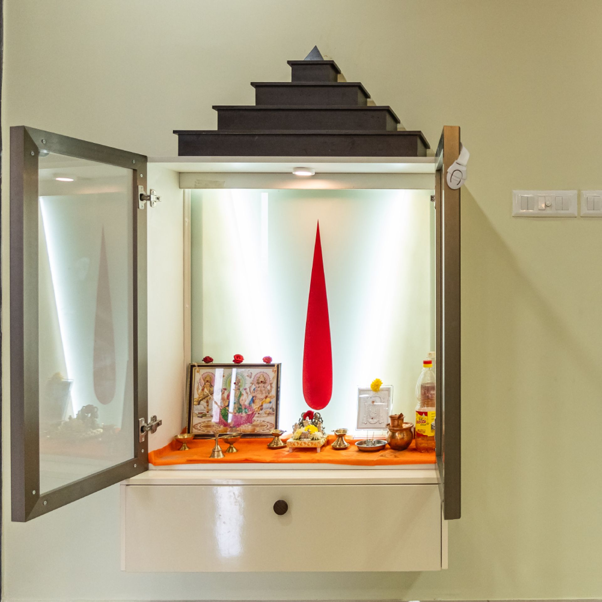 Modern Wall-Mounted Pooja Cabinet Design with Soft Lighting and Drawer ...