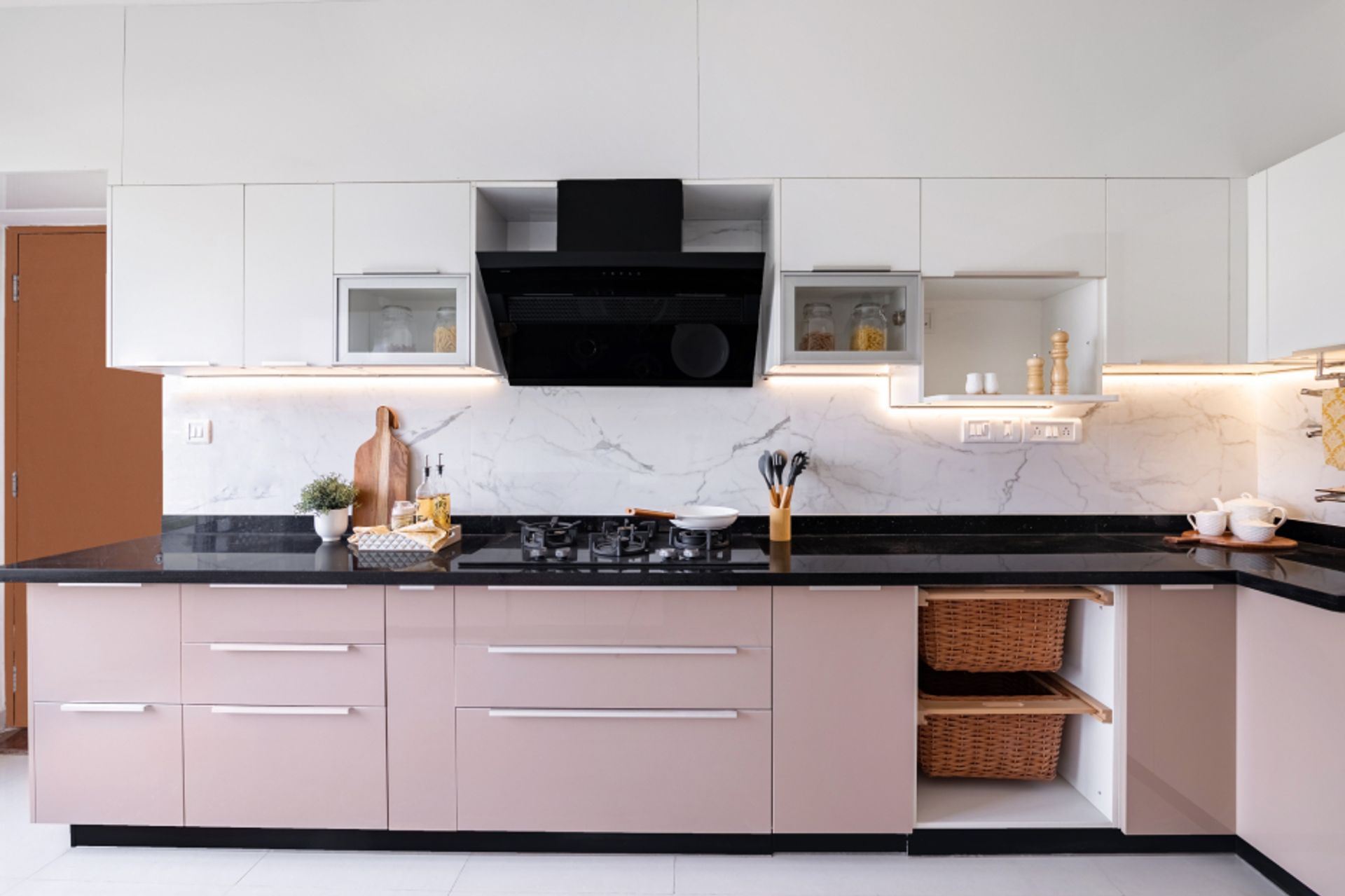 Spacious Kitchen Design With Pink And White Storage Cabinets | Livspace