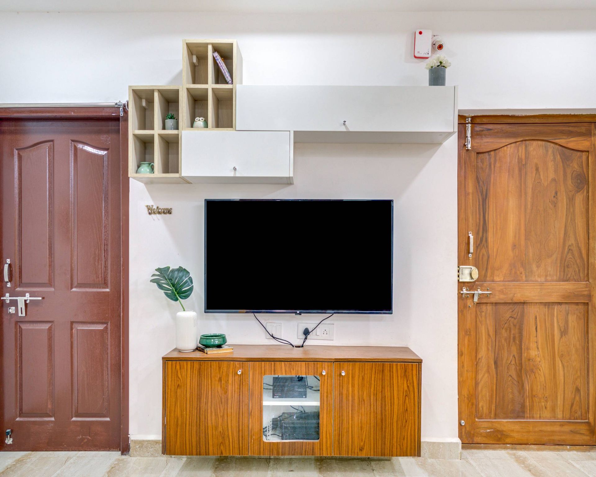Wall-Mounted White And Brown TV Unit Design | Livspace
