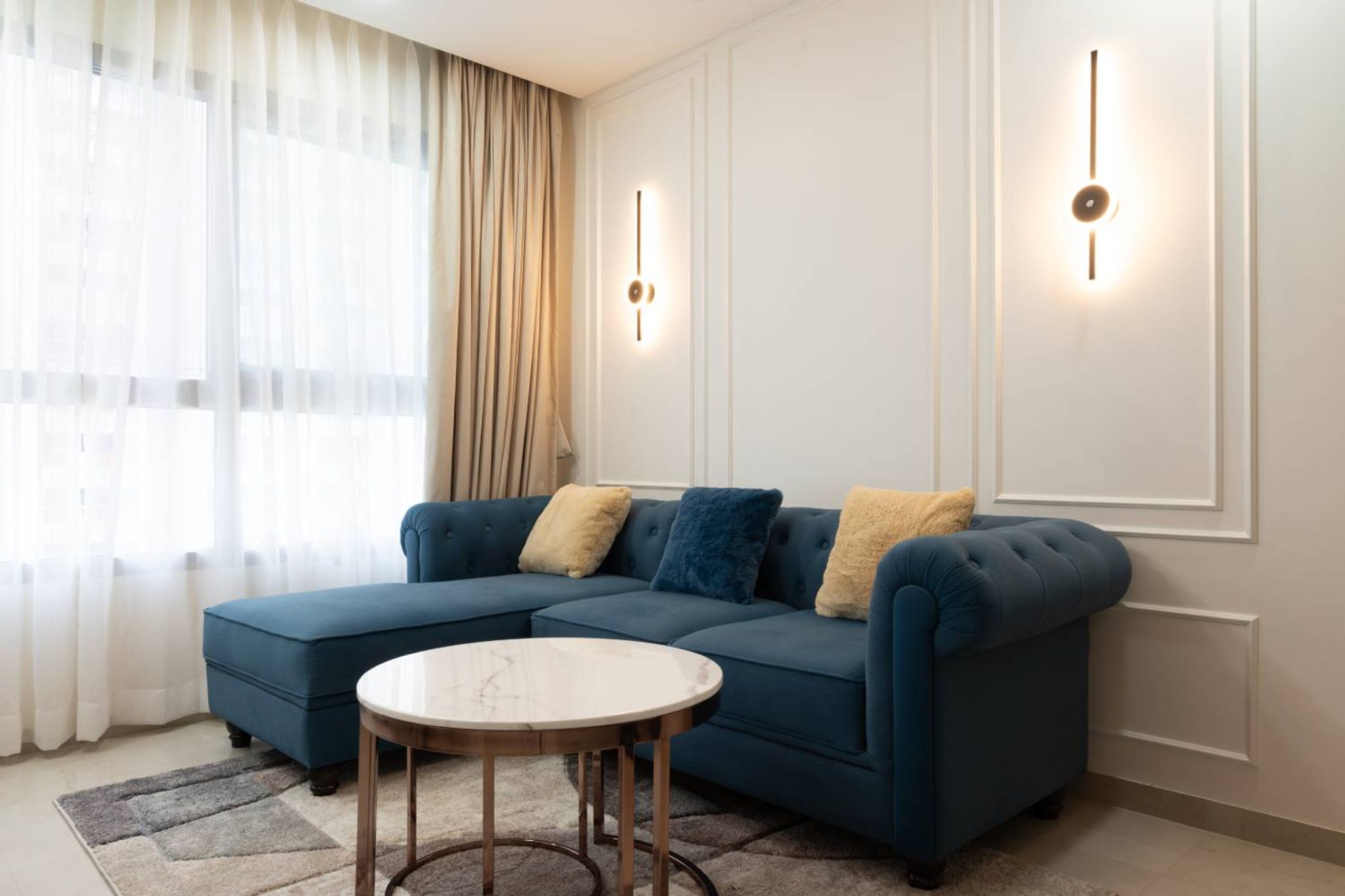 Living Room Design with Modern L-Shaped Dark Blue Sofa and Round Table ...