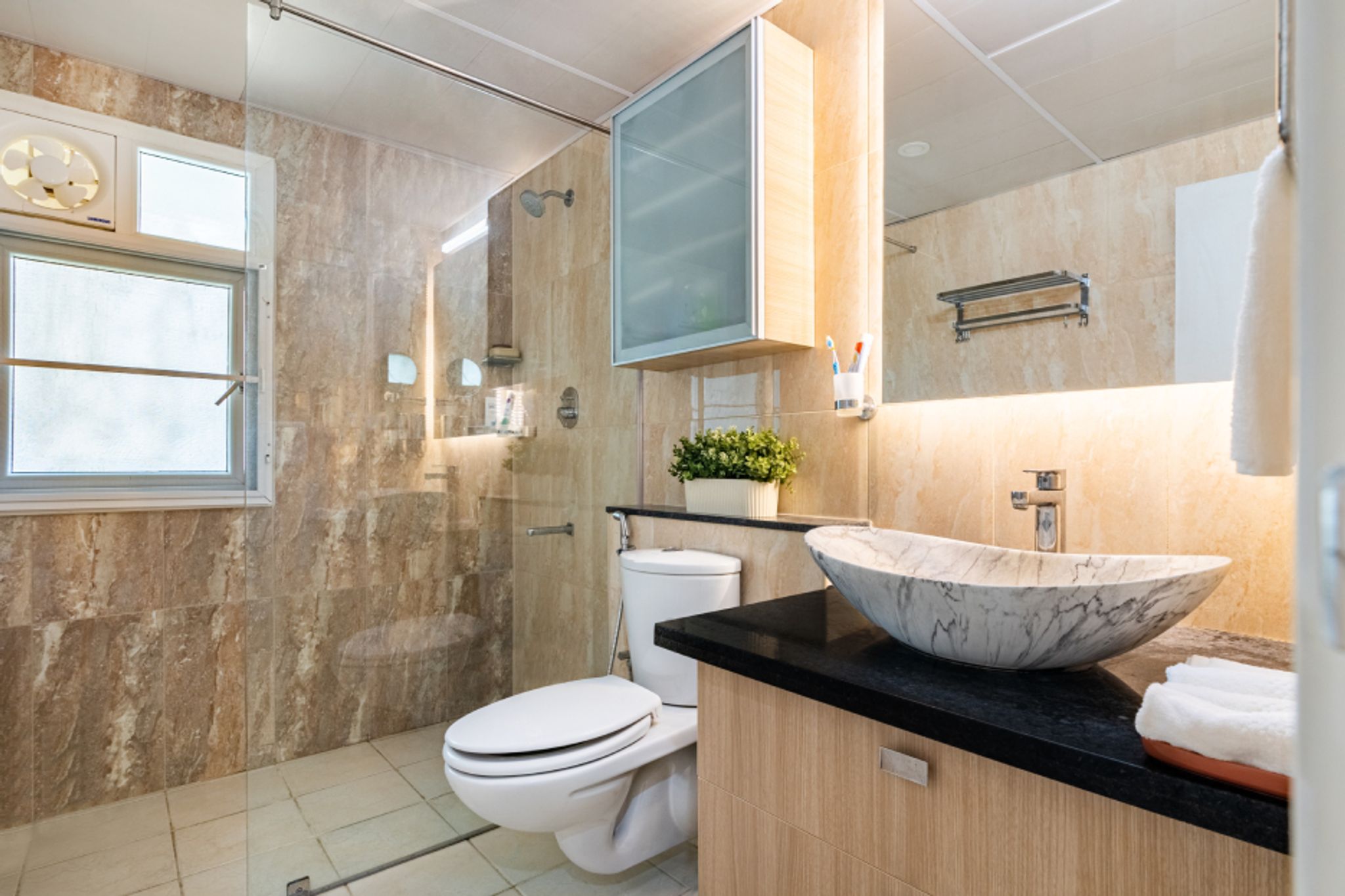 Compact Bathroom Design With Brown Textured Tiles - 7X6 Ft | Livspace