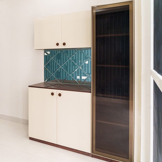 Minimal Crockery Unit Design With Cabinets and White Tall Glass Storage ...
