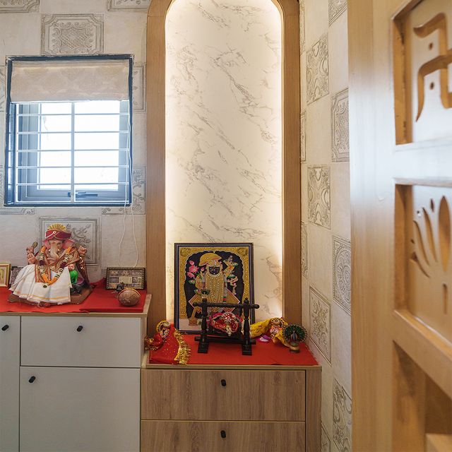 Traditional Pooja Room Design with Marble Backdrop and Hidden Storage ...