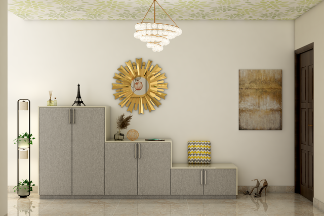 Spacious Foyer Design With Grey Storage Unit And Chandelier | Livspace