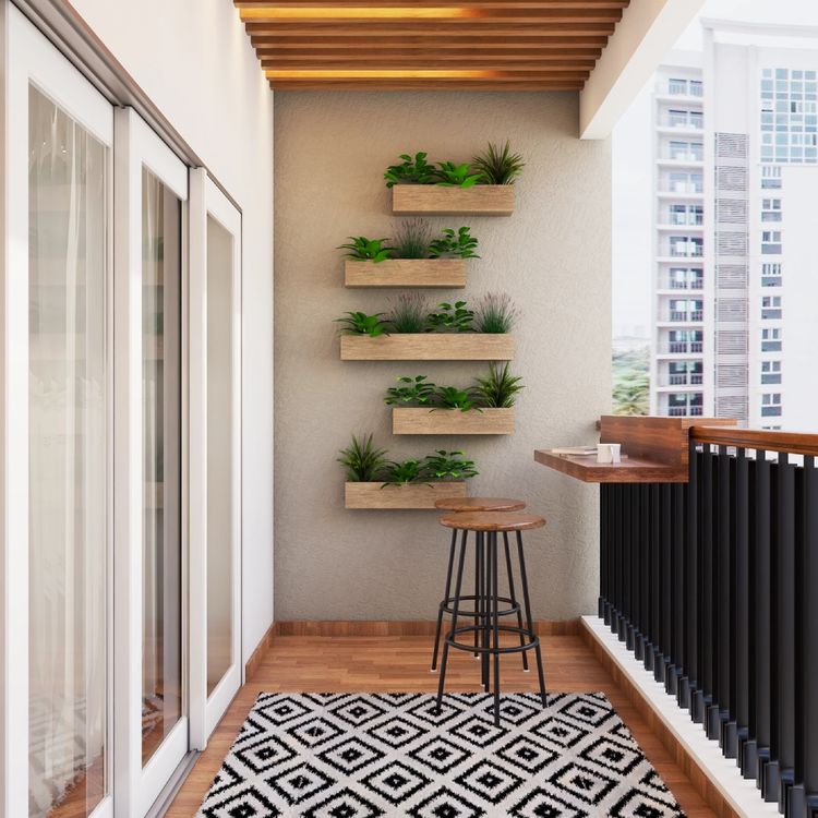 Compact Balcony Design With Wooden Table and Wall Planters | Livspace