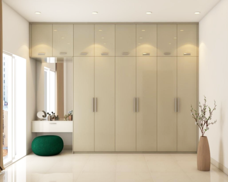 Spacious Beige Wardrobe with Green Ottoman and Dressing Mirror | Livspace