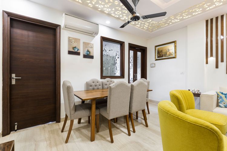 6-Seater Grey And Wood Dining Room Design With Tufted Chairs | Livspace