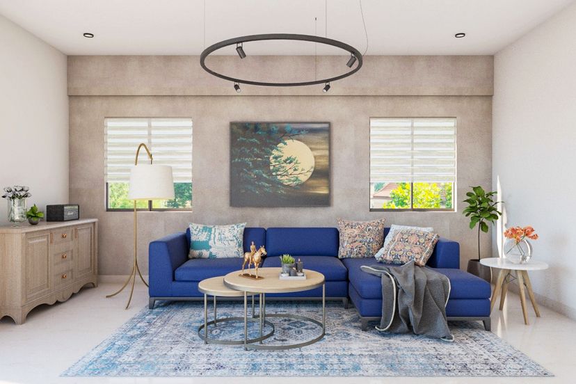 Spacious Living Room Design With Blue Sofa And Storage Unit | Livspace