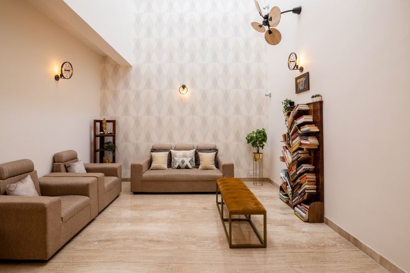 Living Room Design With An Ottoman With Orange Cushioning | Livspace