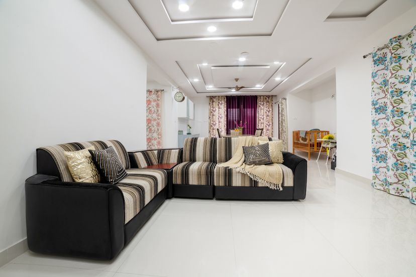 Drawing Room Design With White Walls And Flooring | Livspace